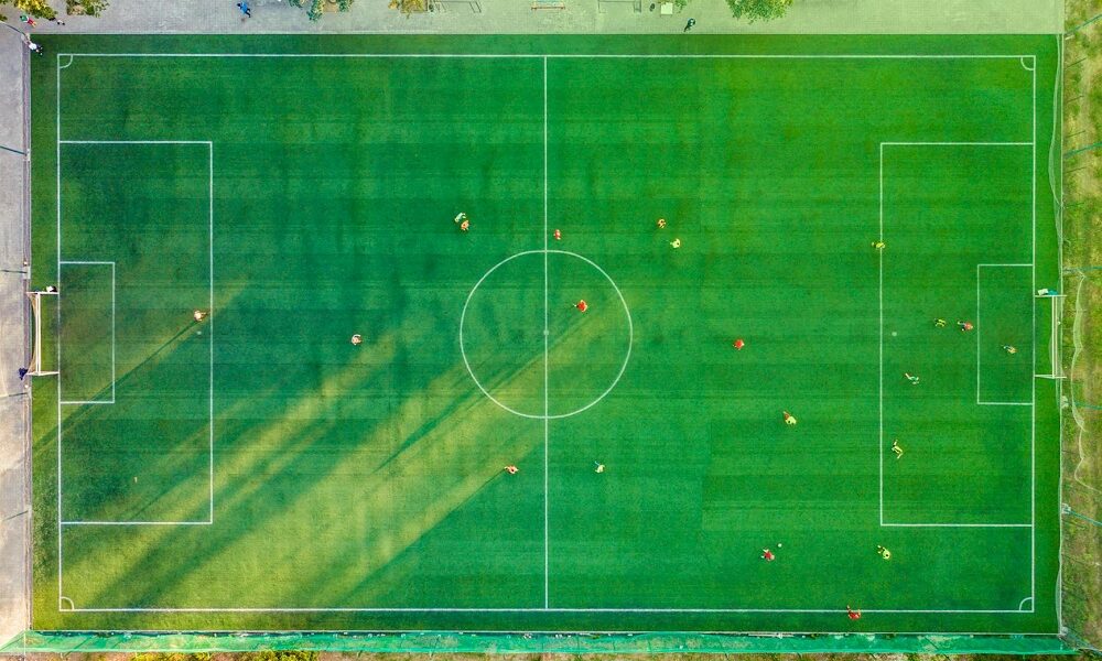 How does football strengthen community in the UK?